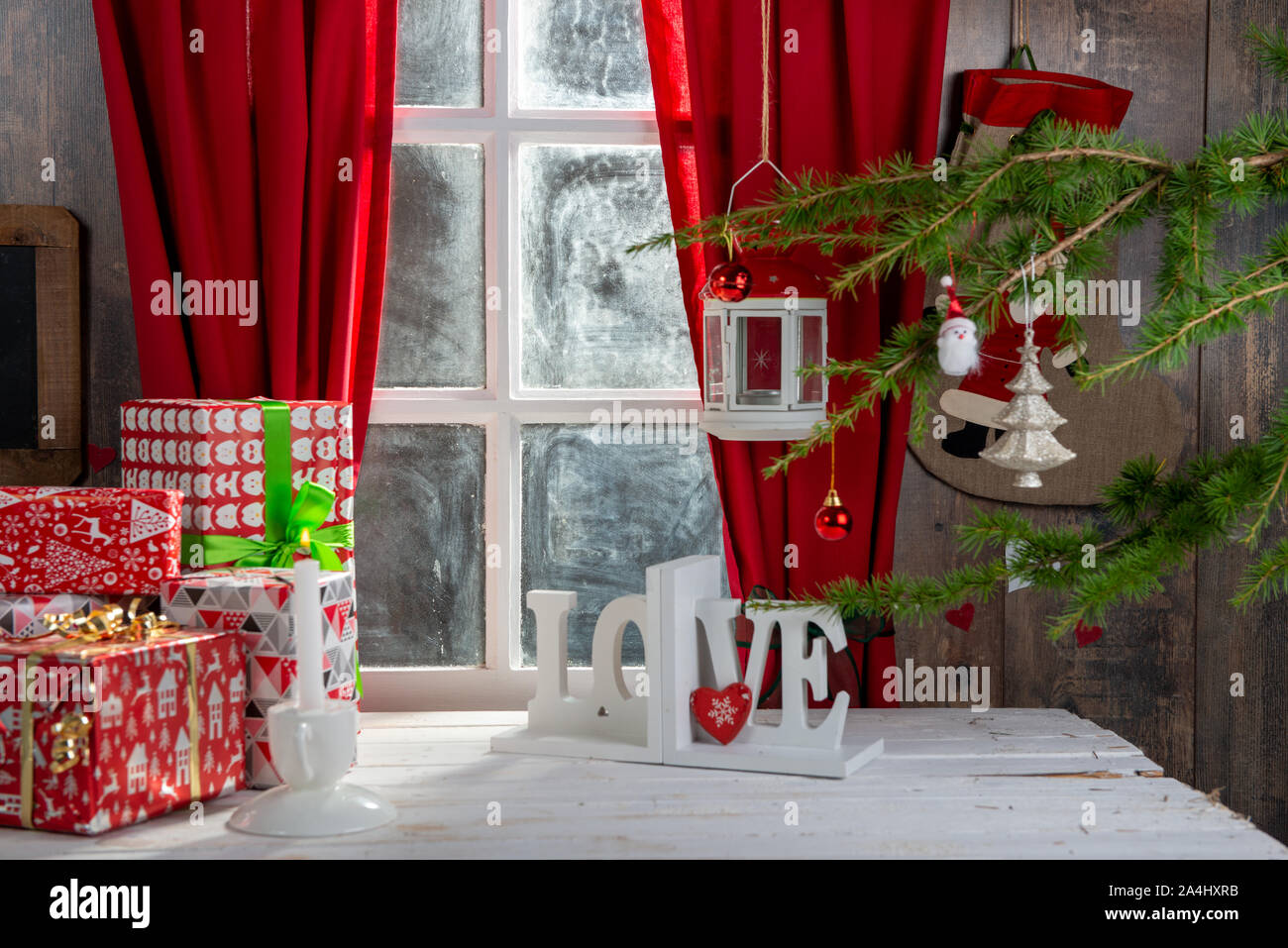 the Christmas gifs decoration near the rustic window Stock Photo - Alamy