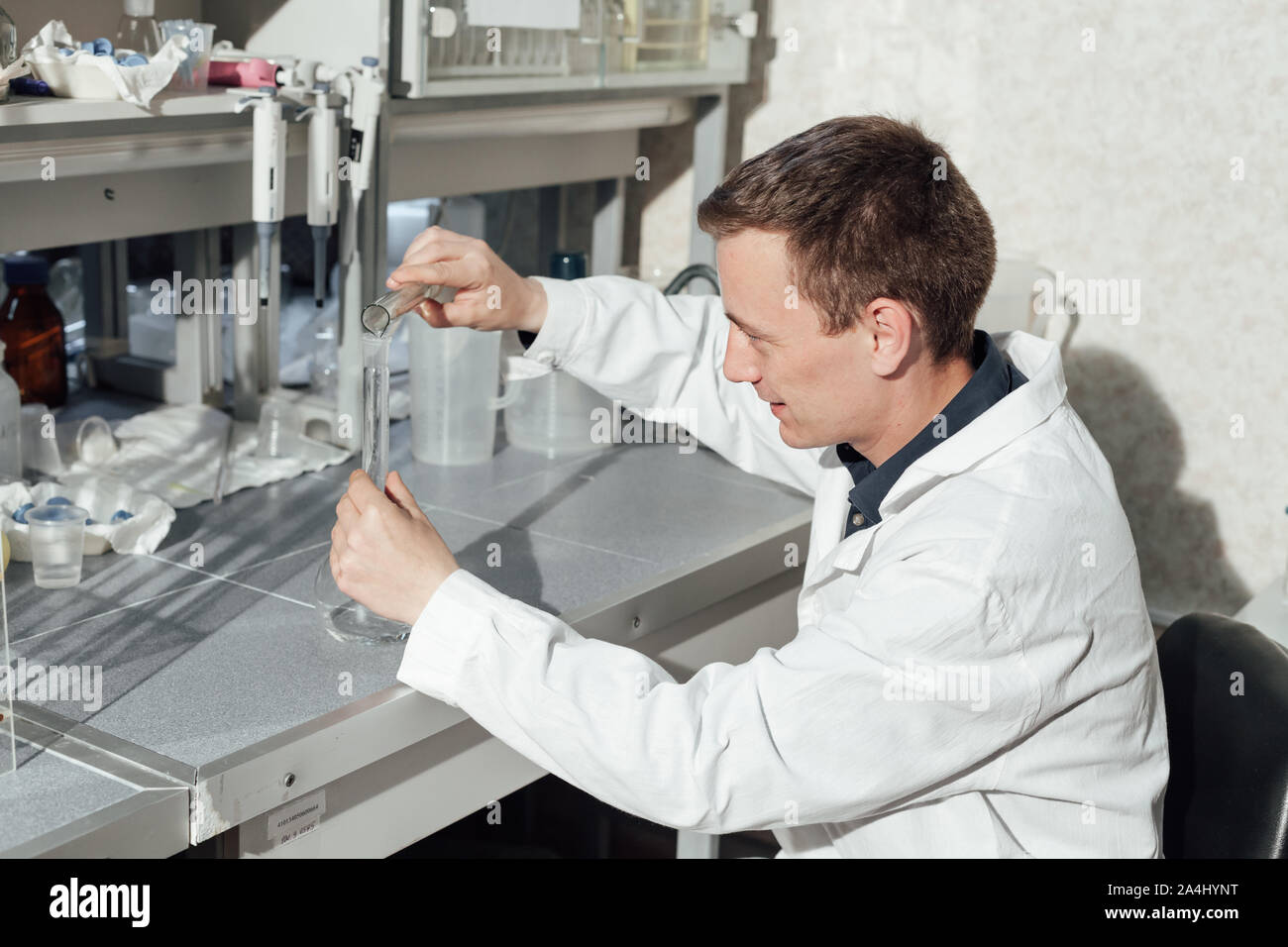 scientist conducts chemical experiments with liquids in the medical ...
