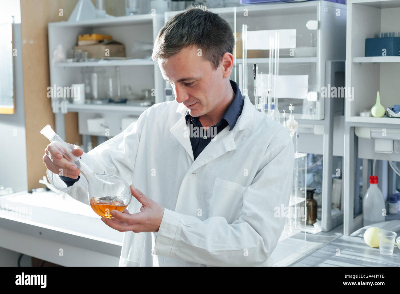 scientist conducts chemical experiments with liquids in the medical ...