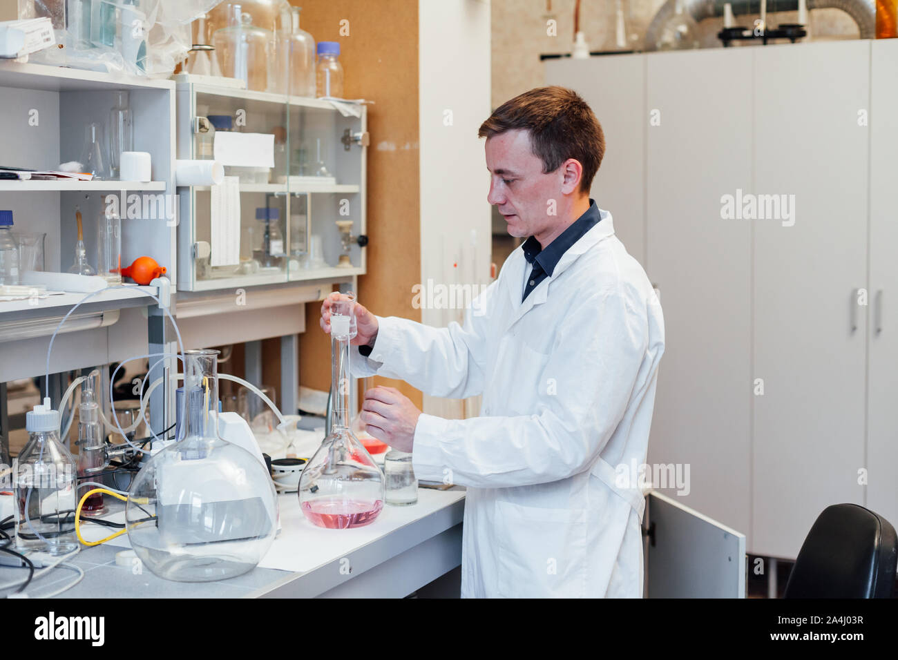 scientist conducts chemical experiments with liquids in the medical ...