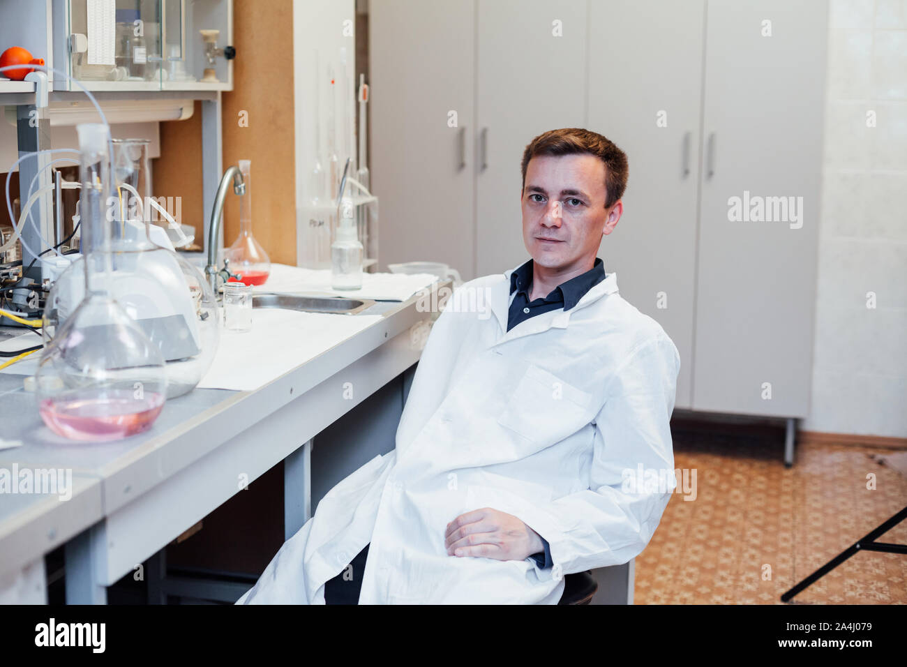 scientist conducts chemical experiments with liquids in the medical ...