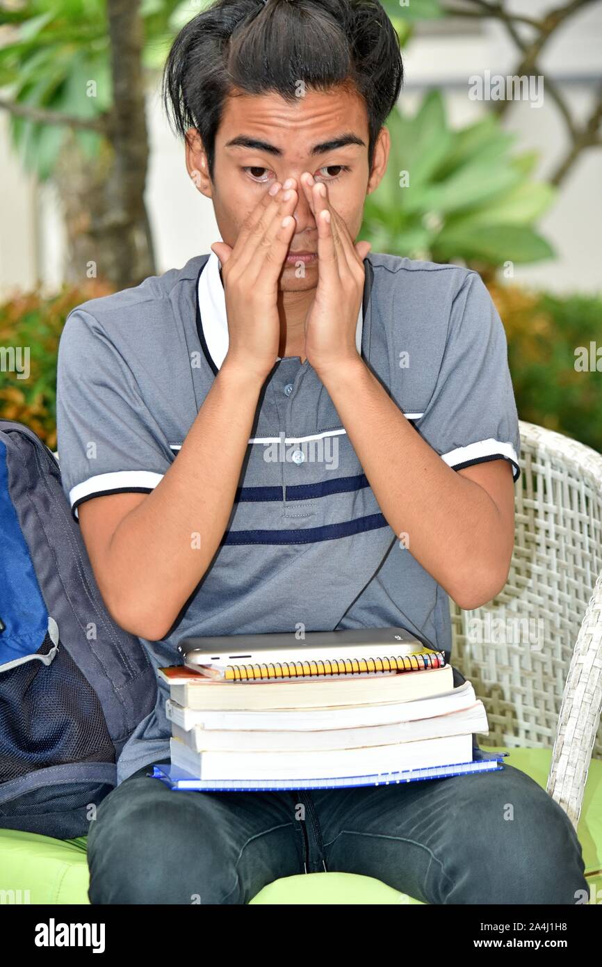 Stressed Young Boy Student With Books Stock Photo - Alamy