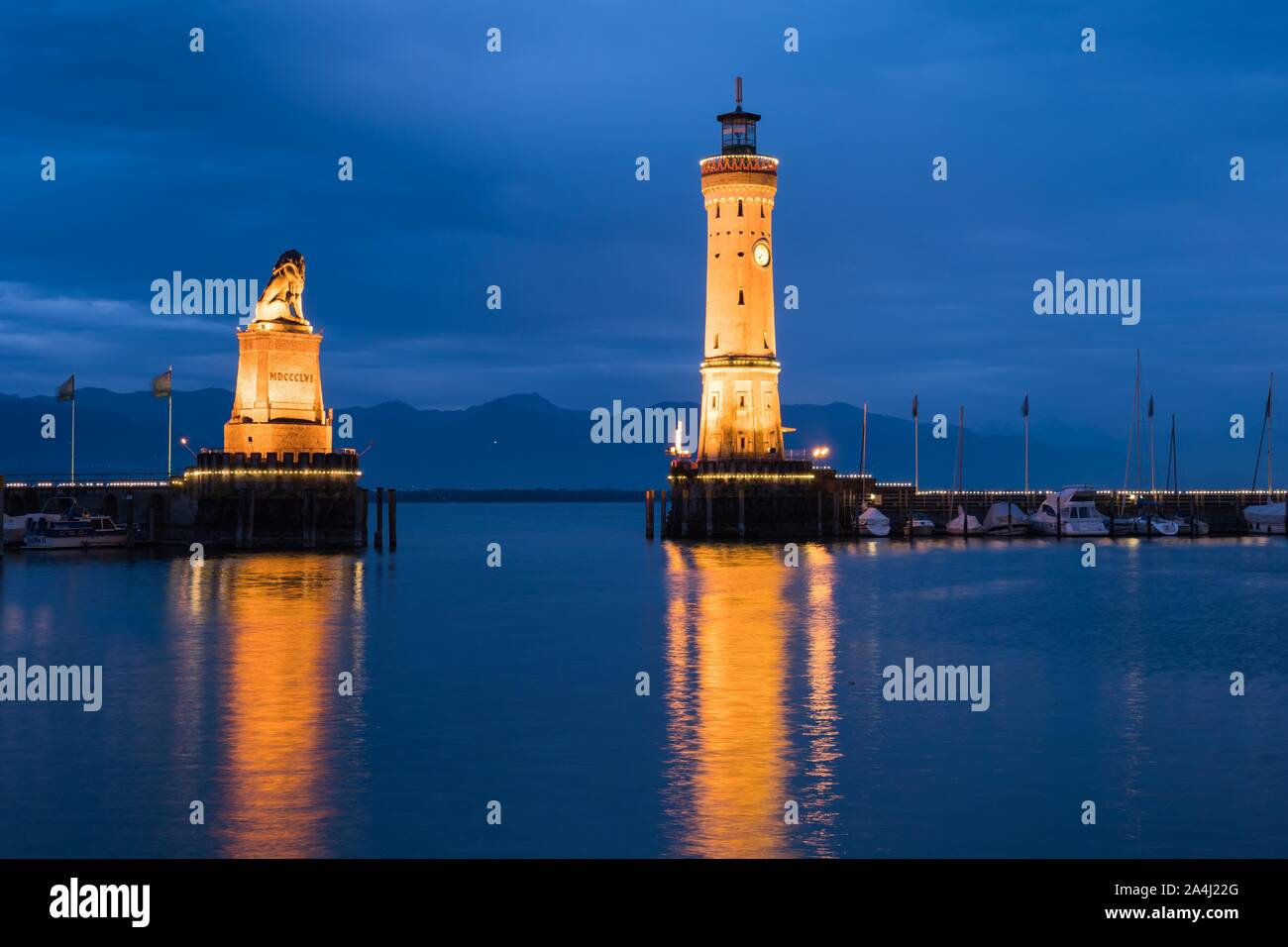 Bavarian lion and lighthouse in the harbour, blue hour, twilight, water ...