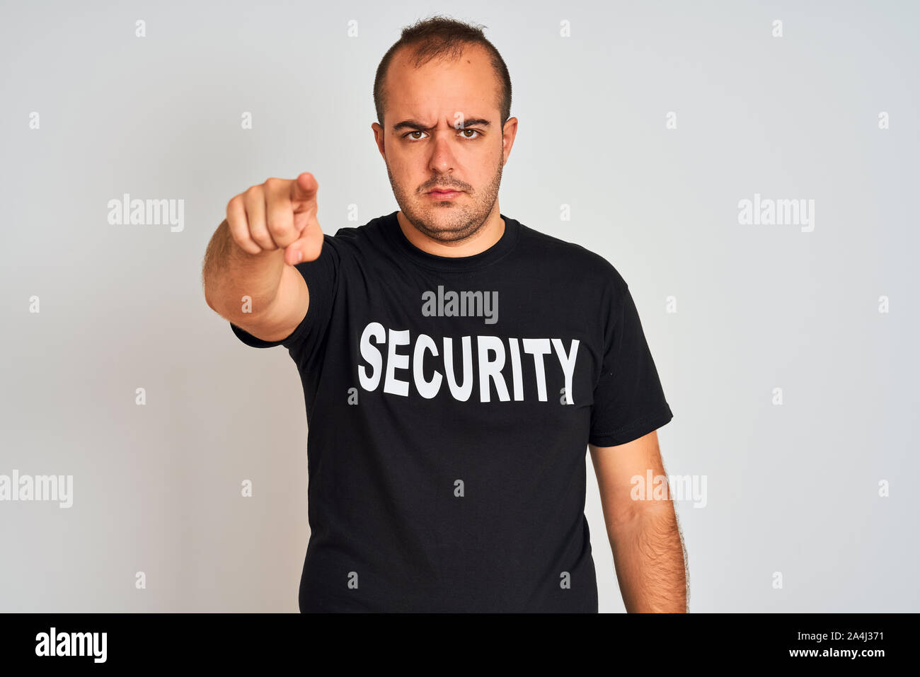 Young safeguard man wearing security uniform standing over isolated ...