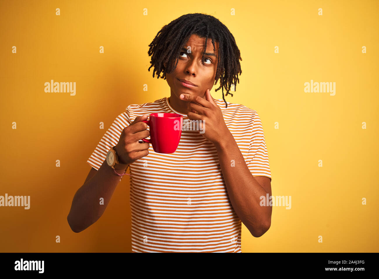 Afro american man with dreadlocks drinking a cup of coffee over ...
