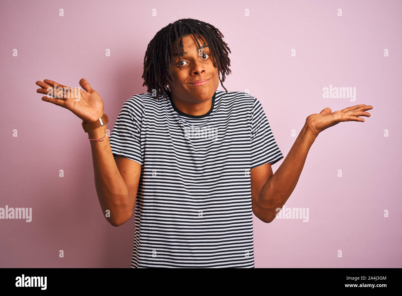 Afro man with dreadlocks wearing navy striped t-shirt standing over ...