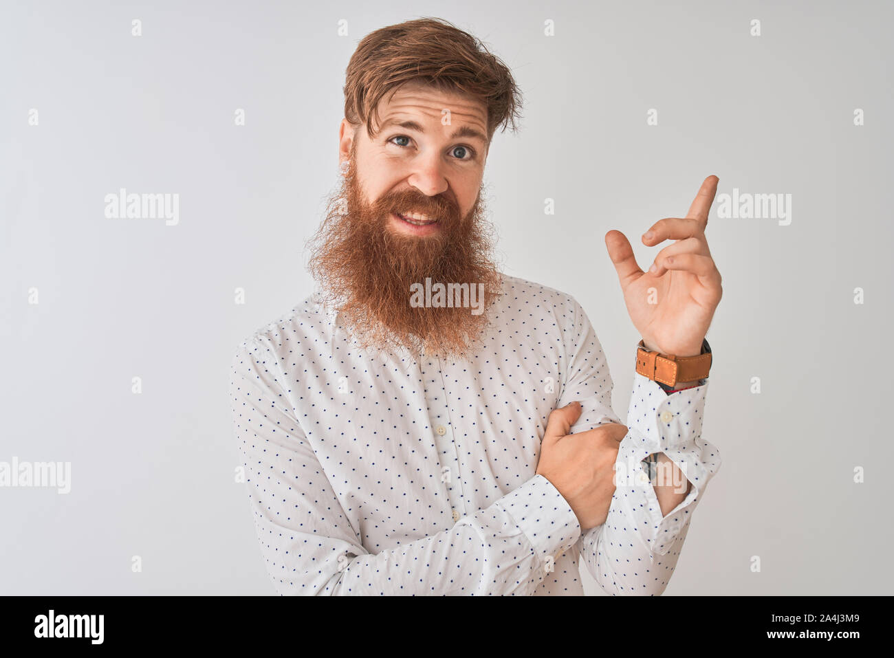Young redhead irish man wearing shirt standing over isolated white ...