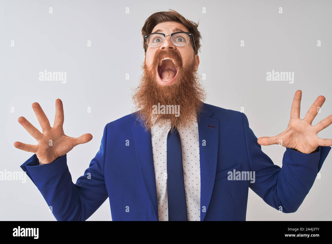 Young redhead irish businessman wearing suit and glasses over isolated ...