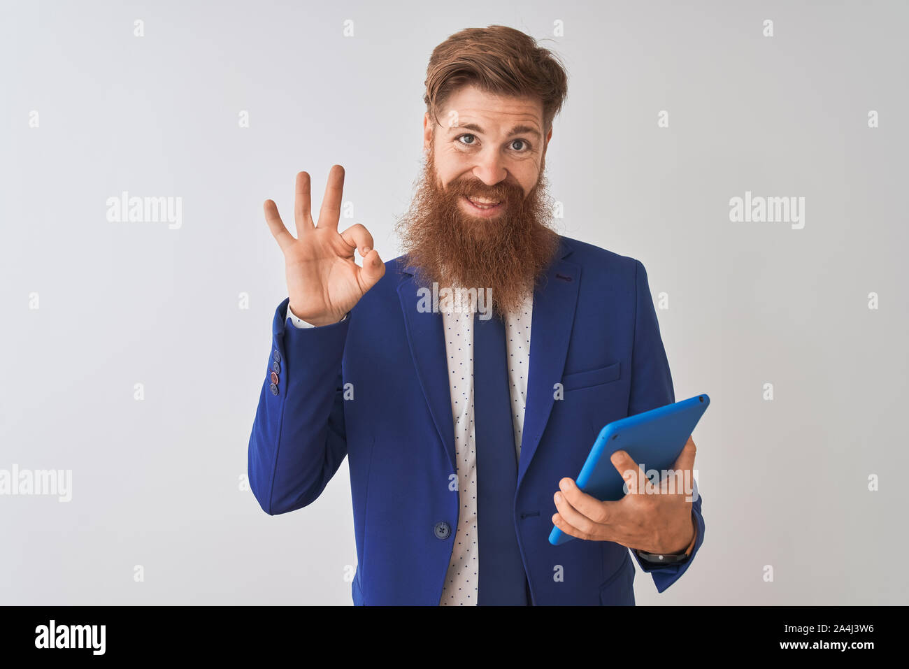 Young redhead irish businessman using tablet over isolated white ...