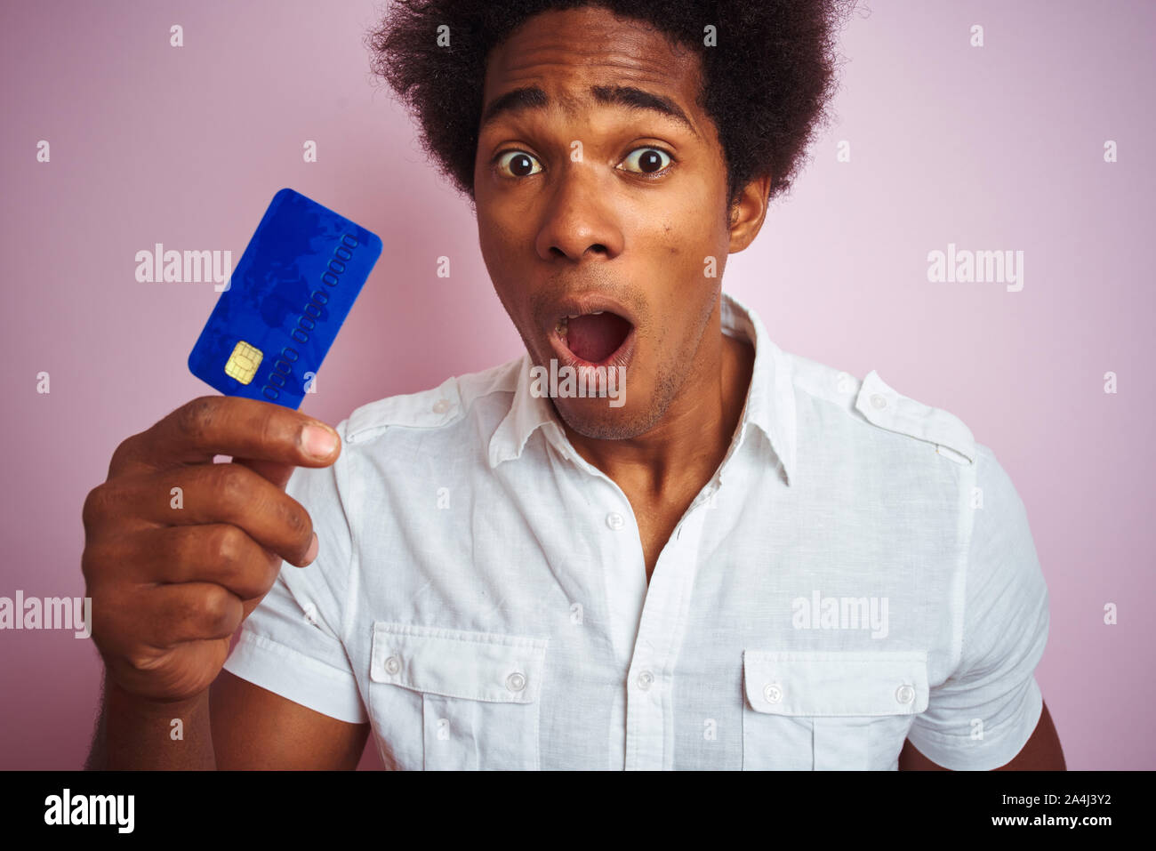Afro american customer man holding credit card standing over isolated ...