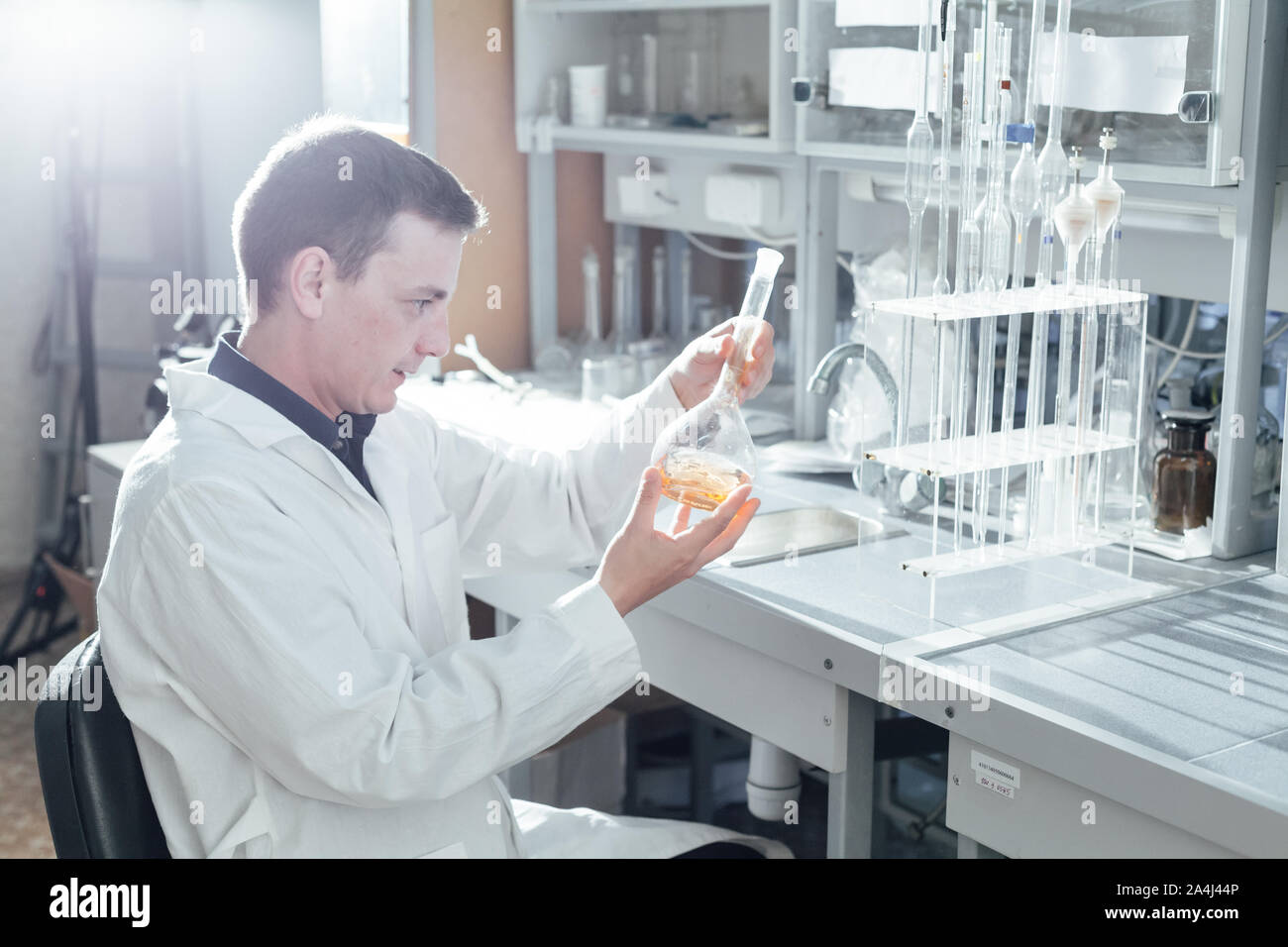 young scientist conducts chemical experiments with liquids in the ...