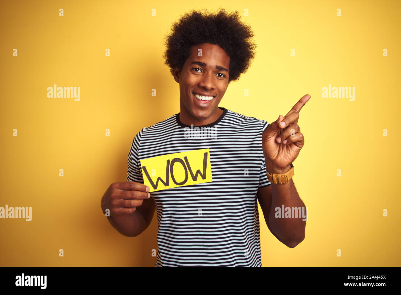 American man with afro hair holding wow banner standing over isolated ...