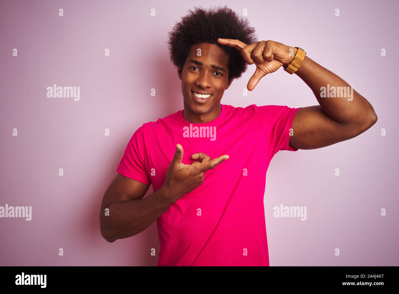Young american man with afro hair wearing t-shirt standing over ...