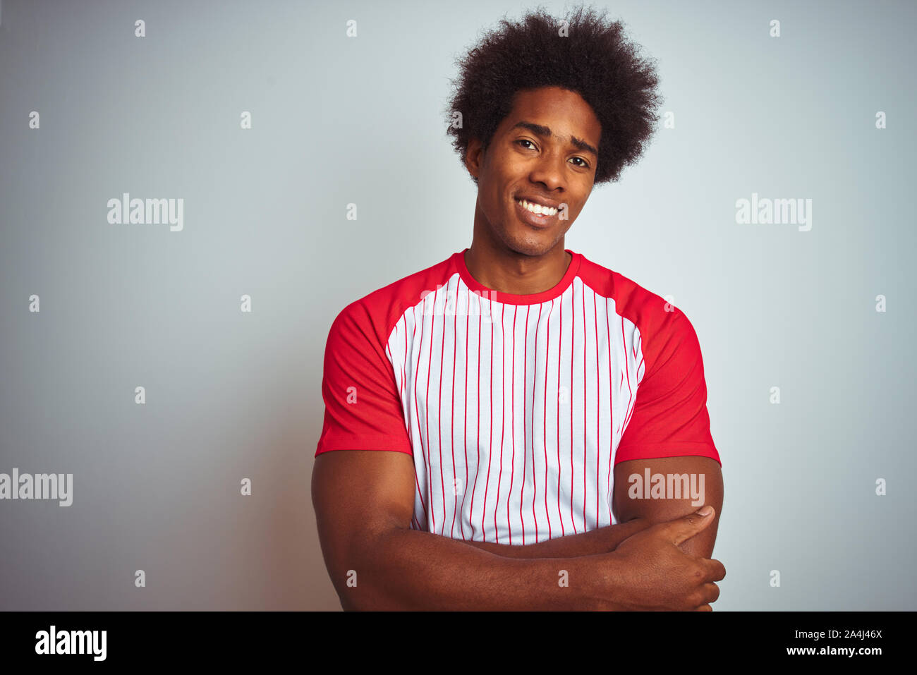 African american man with afro hair wearing red striped t-shirt over ...
