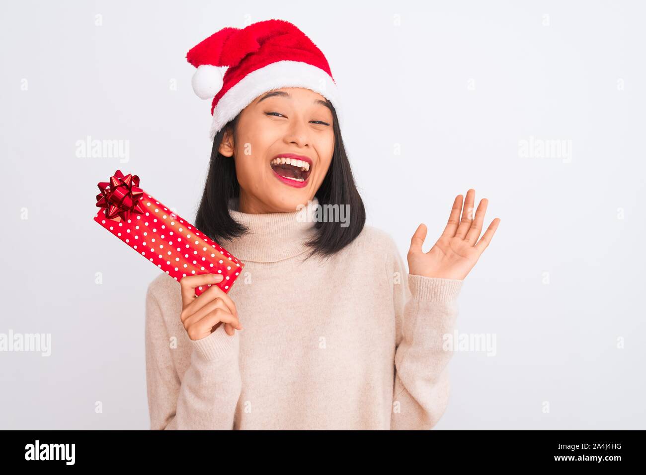 Young chinese cleaner woman wearing gloves holding mop over isolated ...