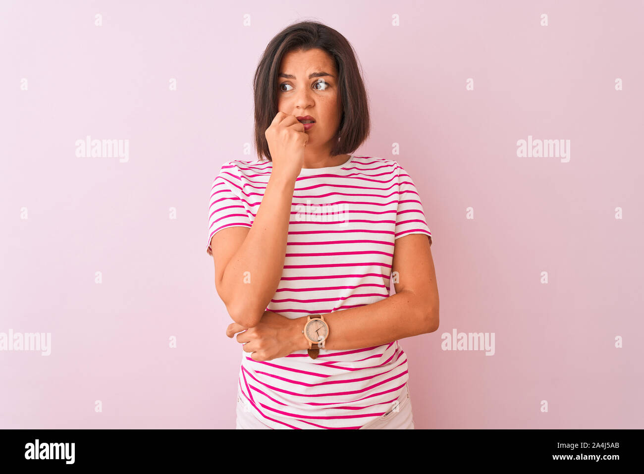 Young beautiful woman wearing striped t-shirt standing over isolated ...