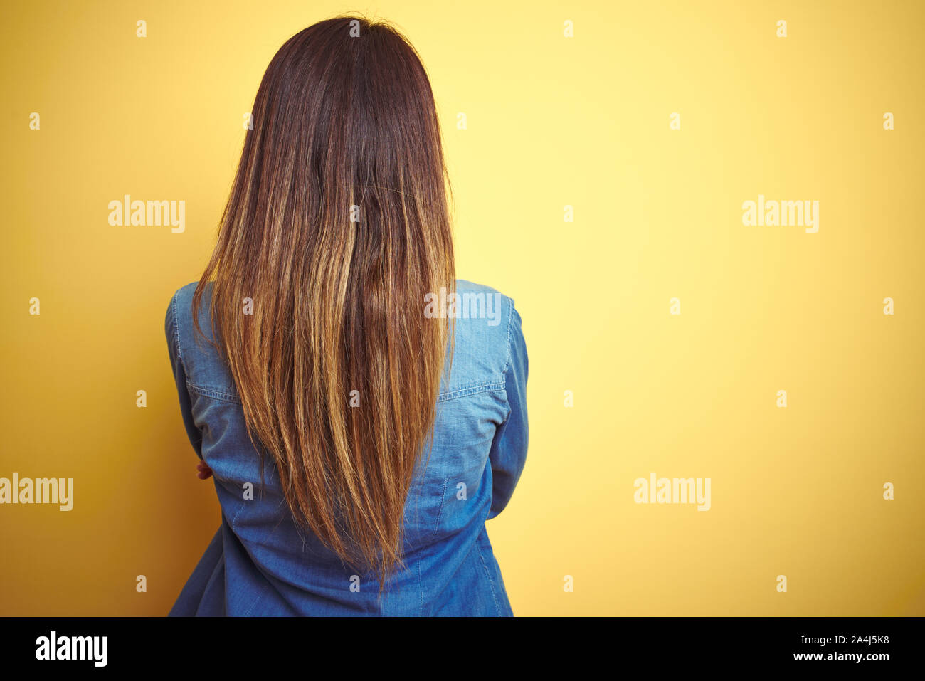 Young beautiful woman standing over yellow isolated background standing ...