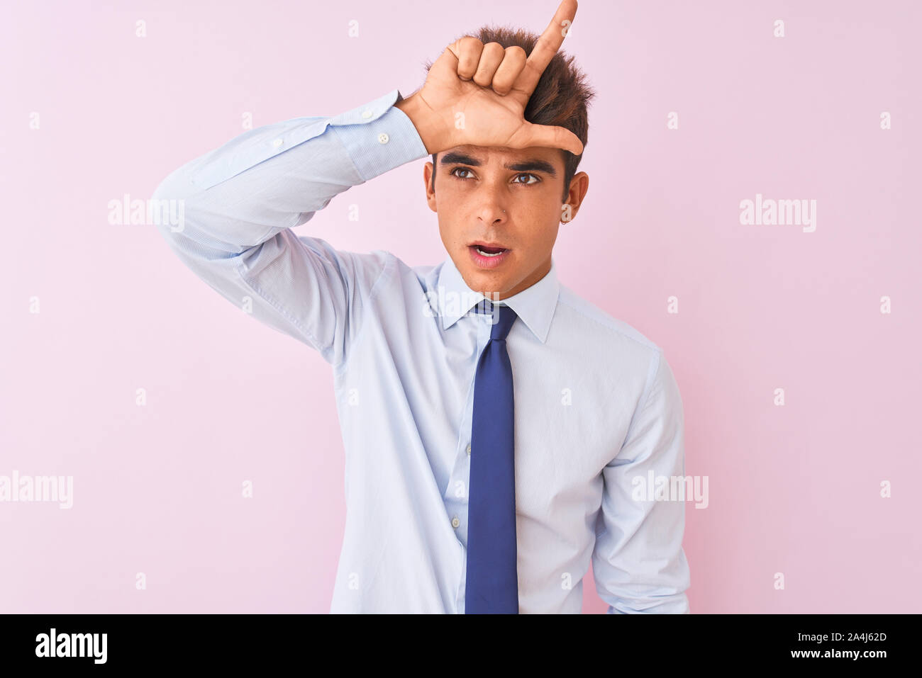 Young handsome businessman wearing shirt and tie standing over isolated ...