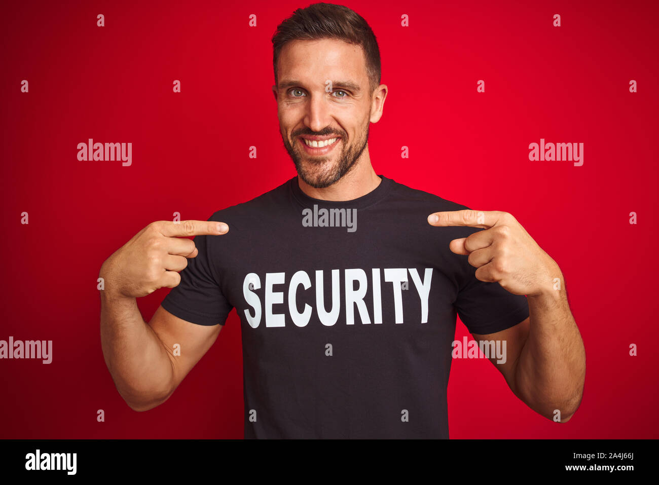 Young safeguard man wearing security uniform over red isolated ...
