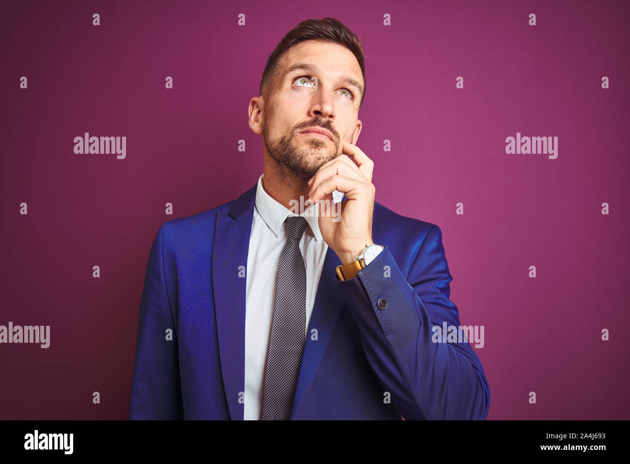 Young handsome business man over purple isolated background with hand ...