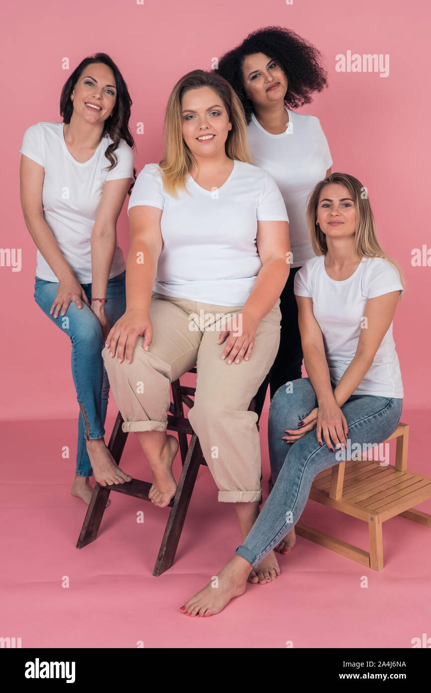 A group of beautiful smiling girls pose full face for the camera on a ...