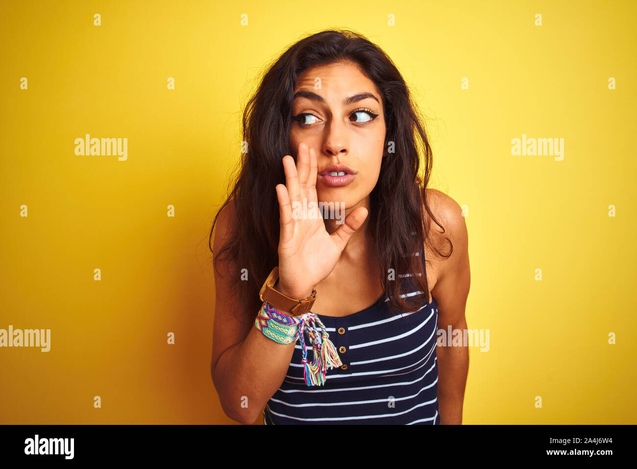Young beautiful woman wearing striped t-shirt standing over isolated ...