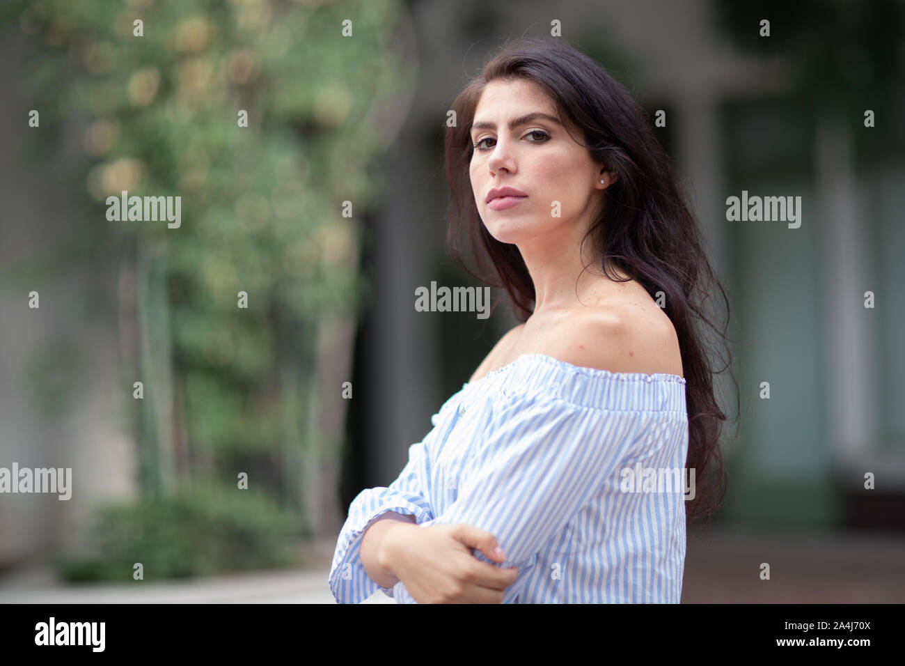 A portrait of a lovely romantic young woman outdoors, inspiringly ...