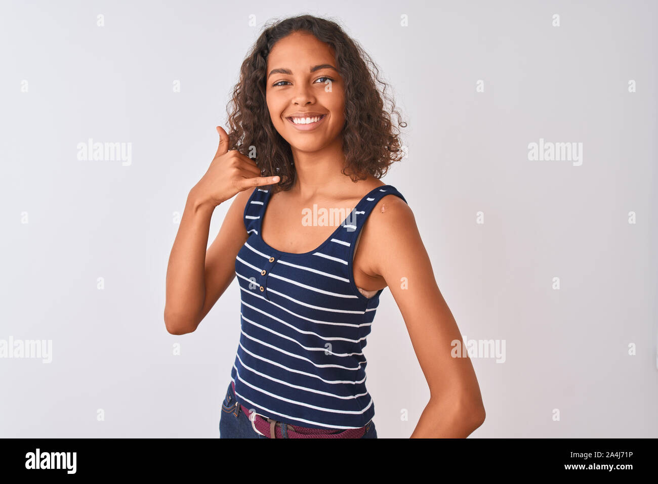 Young brazilian woman wearing striped t-shirt standing over isolated ...
