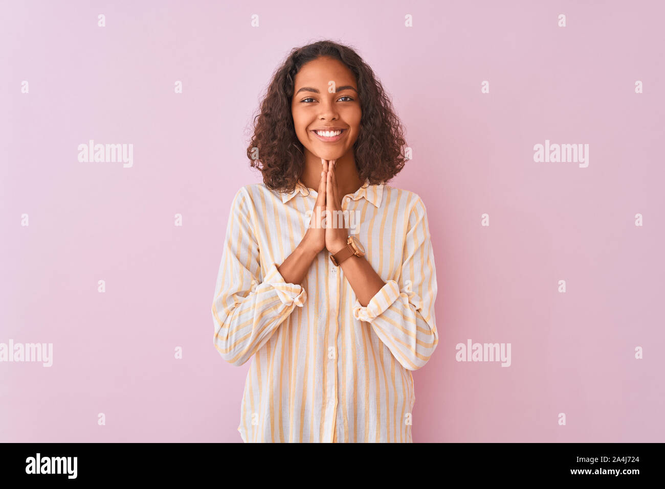 Young Brazilian Woman Wearing Striped Shirt Standing Over Isolated Pink