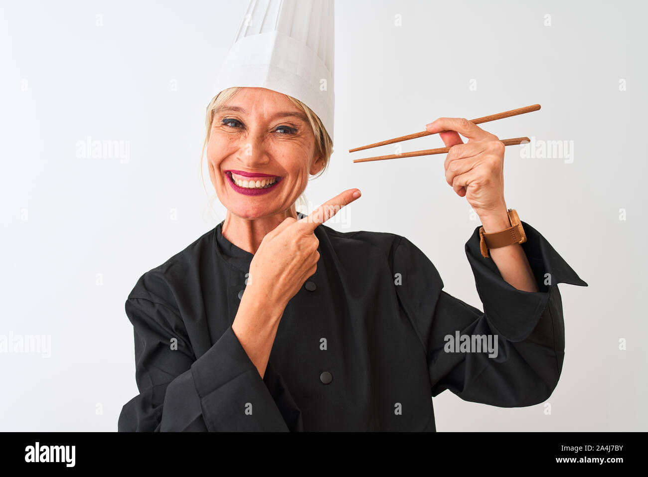 Middle age chef woman wearing cap holding chopsticks over isolated ...