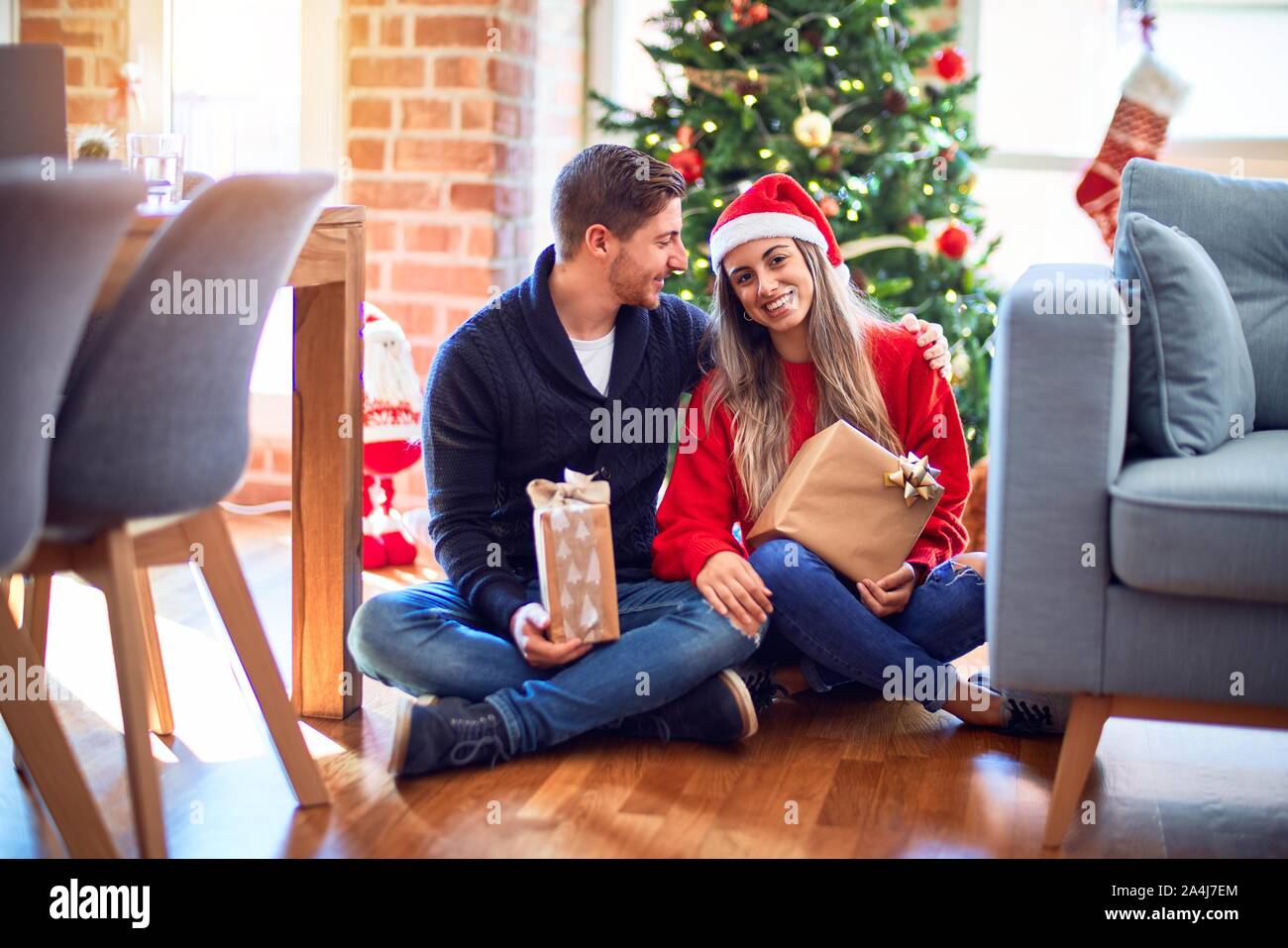 Young beautiful couple smiling happy and confident. Sitting on the ...