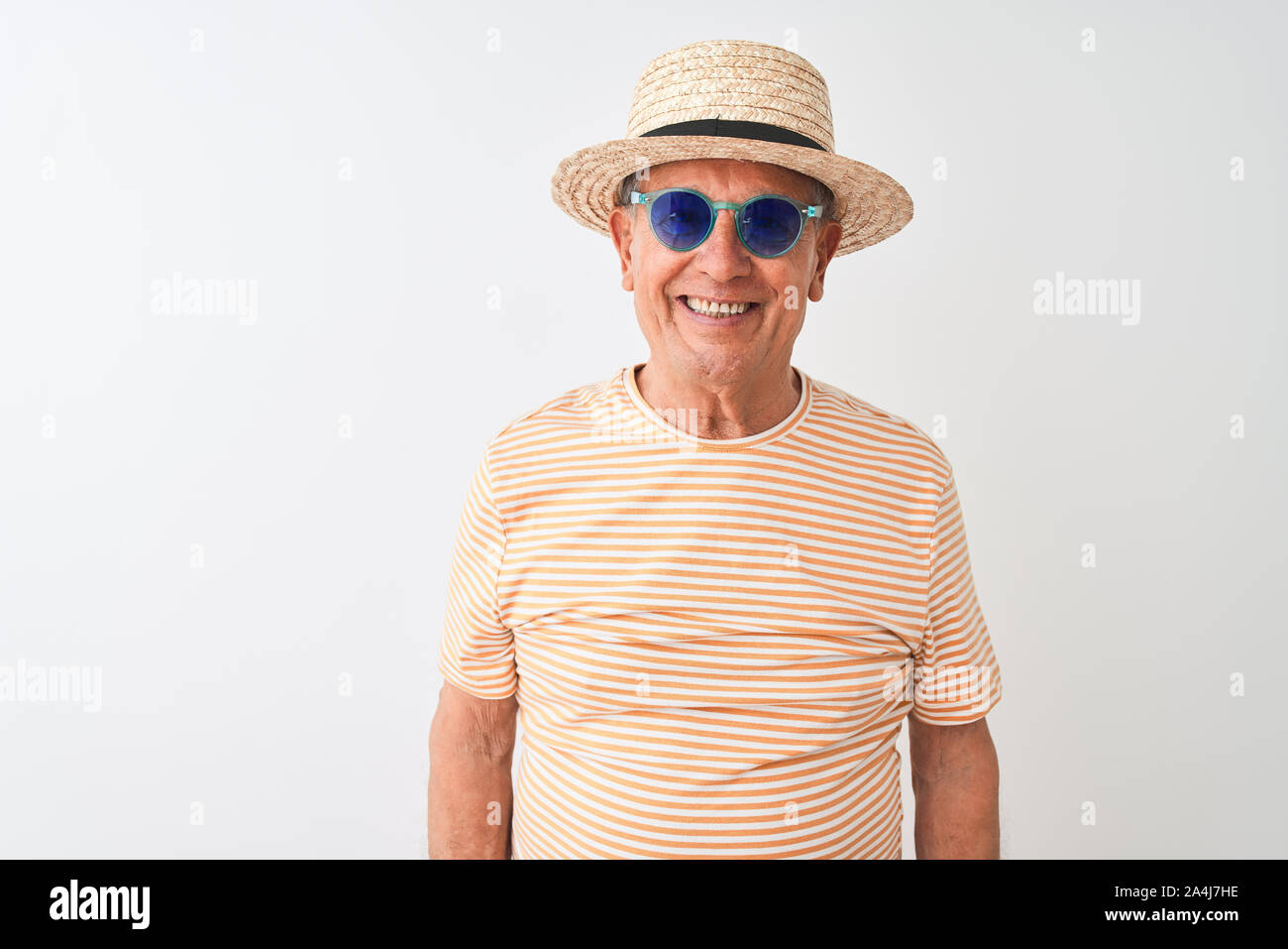 Senior man wearing striped t-shirt sunglasses and sumer hat over ...