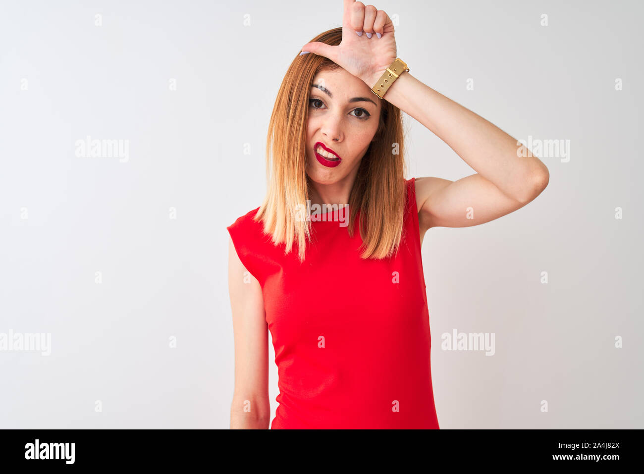 Redhead businesswoman wearing elegant red dress standing over isolated ...