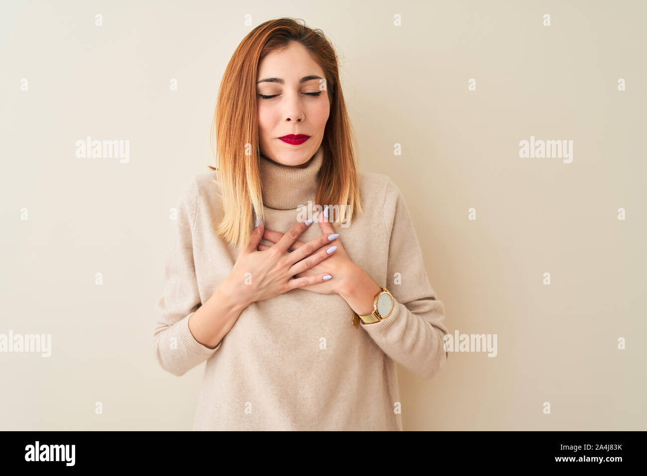 Redhead woman wearing elegant turtleneck sweater standing over isolated ...