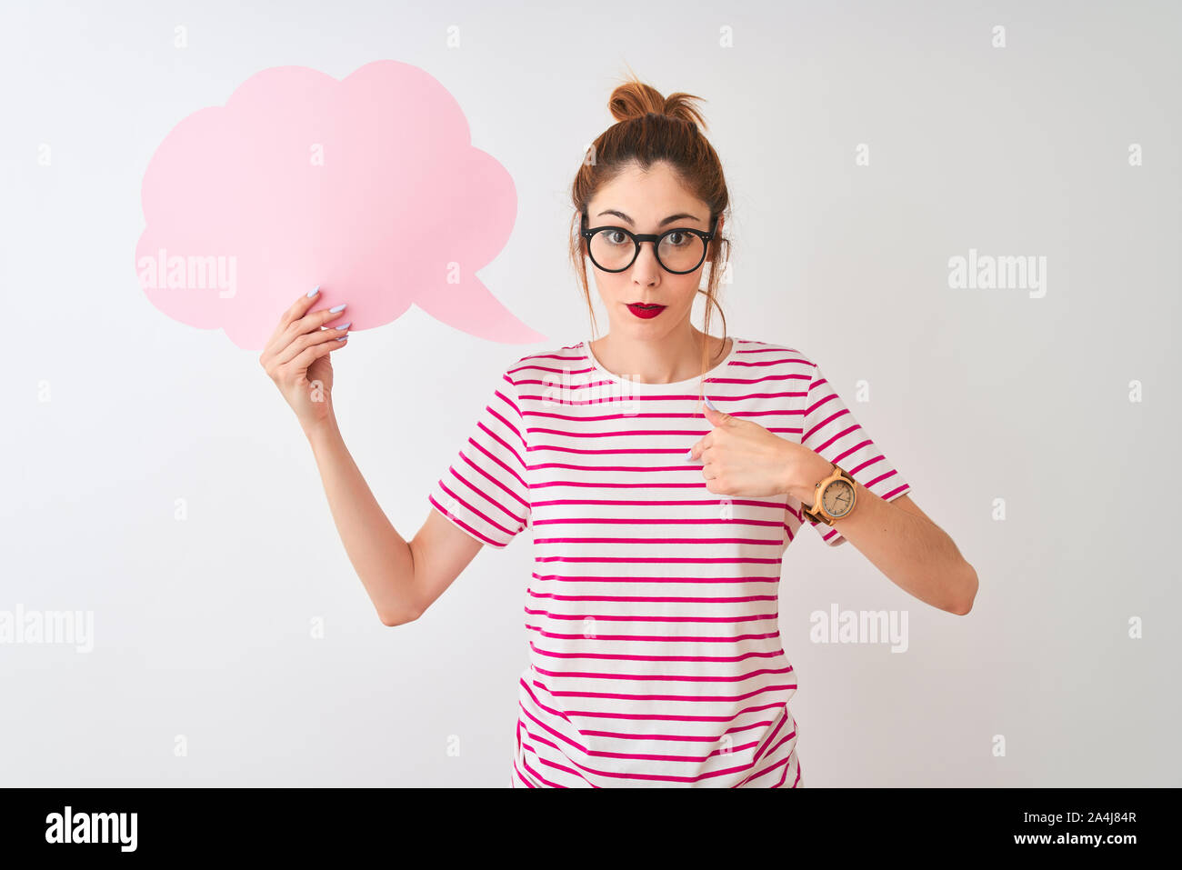 Redhead woman wearing glasses holding cloud speech bubble over isolated ...