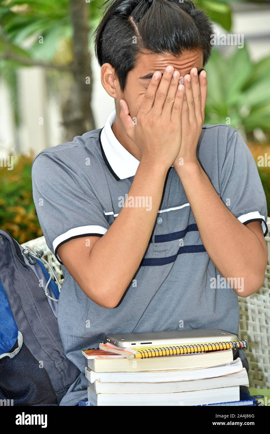 An Ashamed Asian Male Student Stock Photo - Alamy