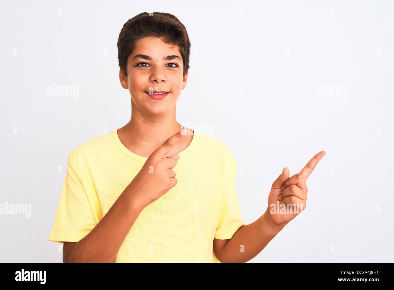 Handsome teenager boy standing over white isolated background smiling ...