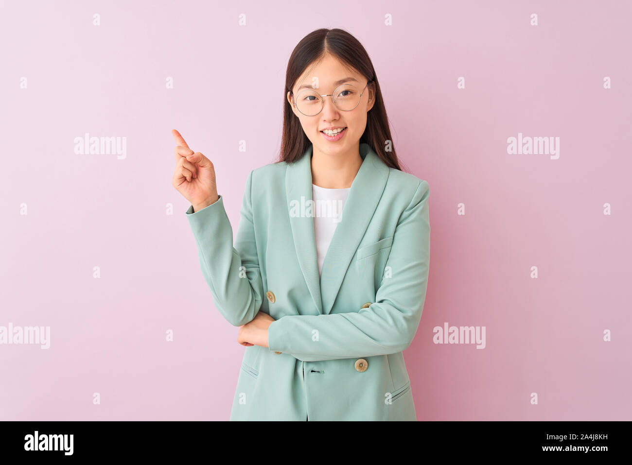 Young chinese businesswoman wearing jacket and glasses over isolated ...