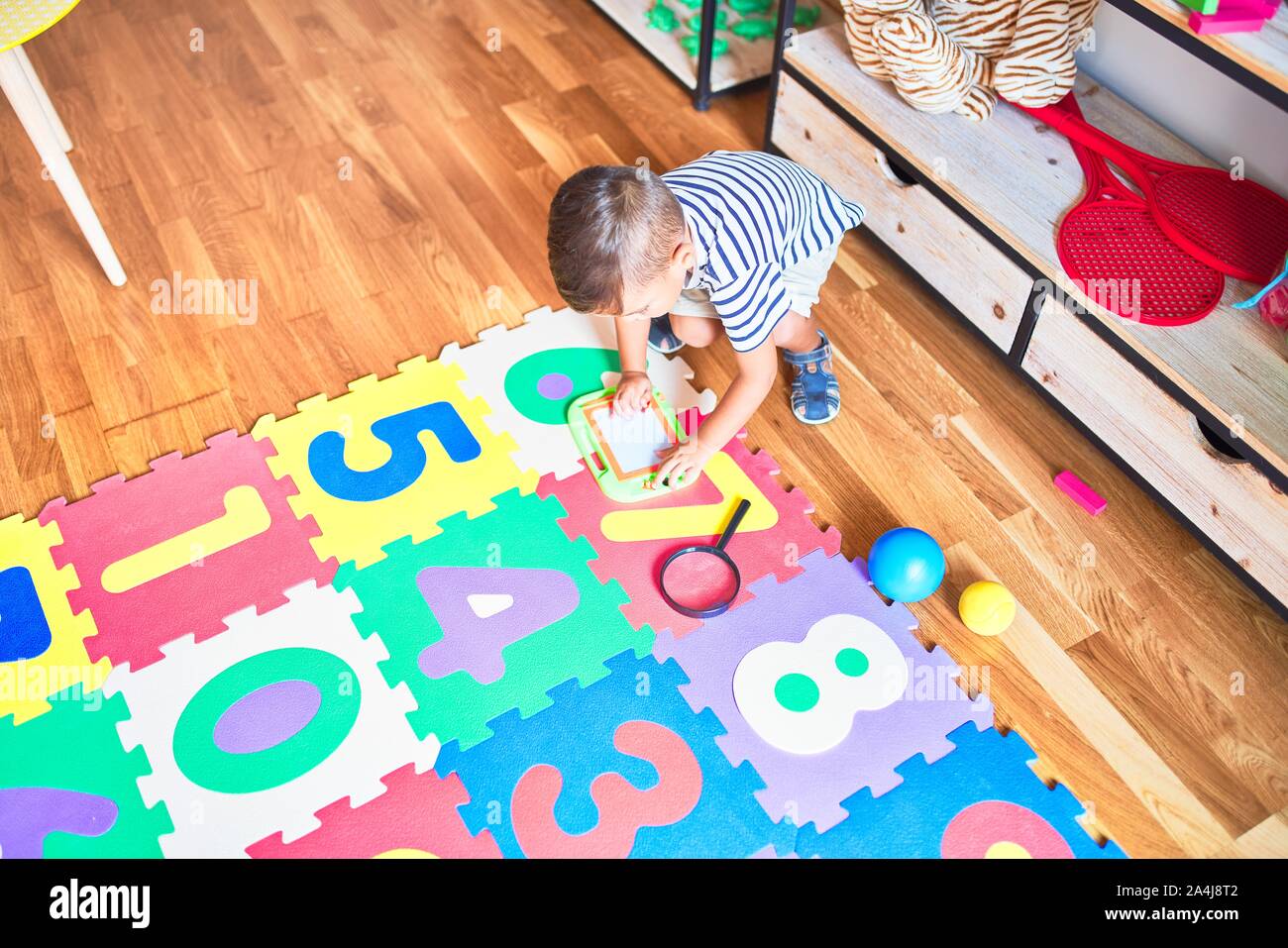 Beautiful toddler boy drawing cute draw using digital board at ...