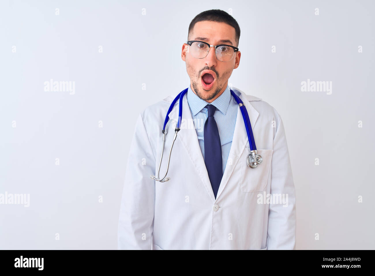 Young doctor man wearing stethoscope over isolated background In shock ...