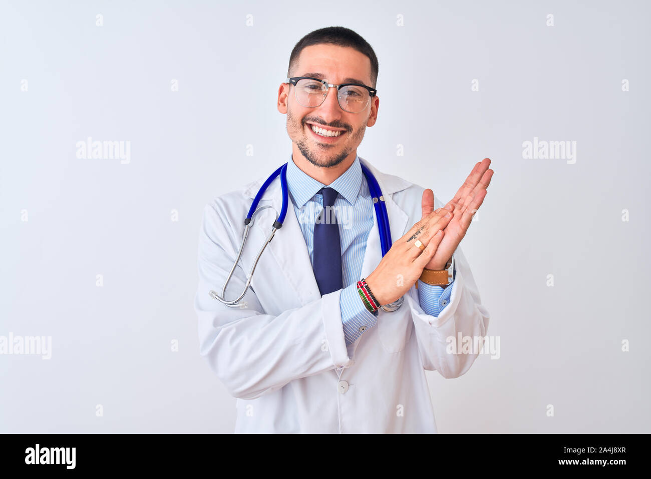 Young doctor man wearing stethoscope over isolated background clapping ...