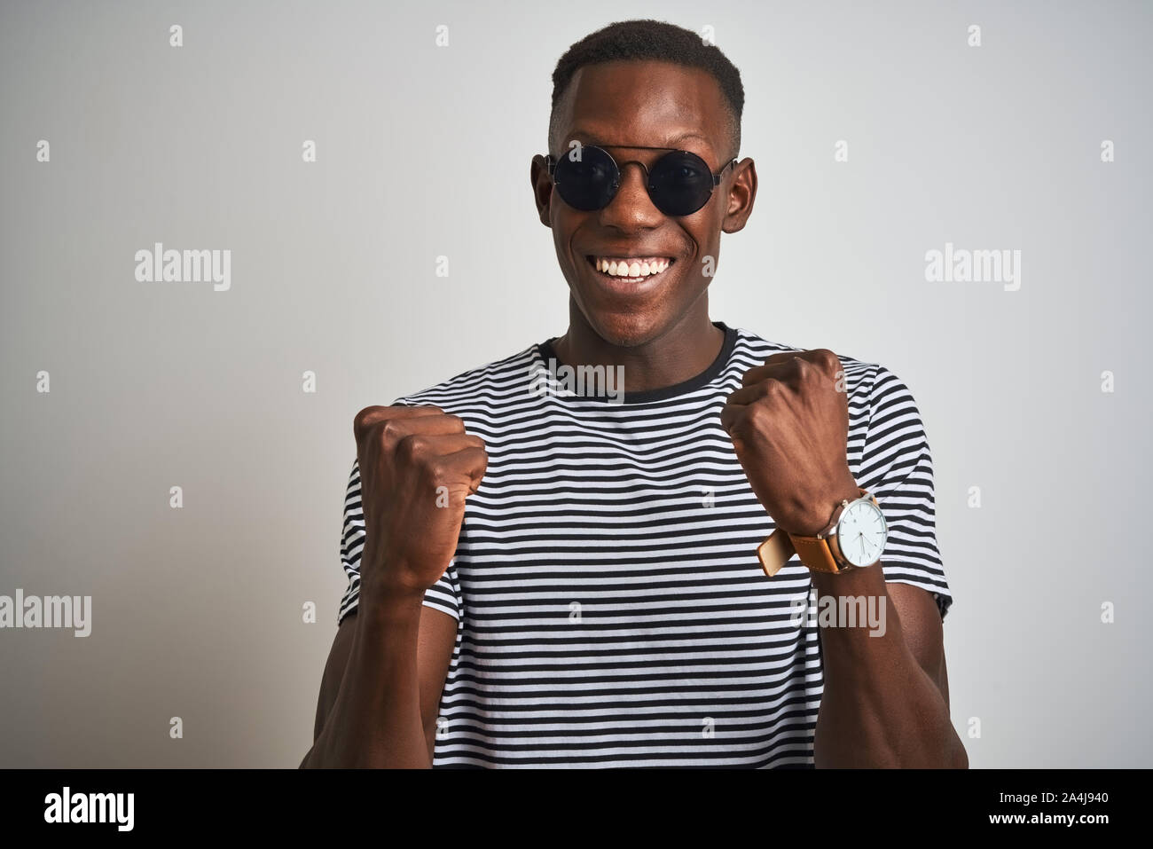 African american man wearing striped t-shirt and sunglasses over ...