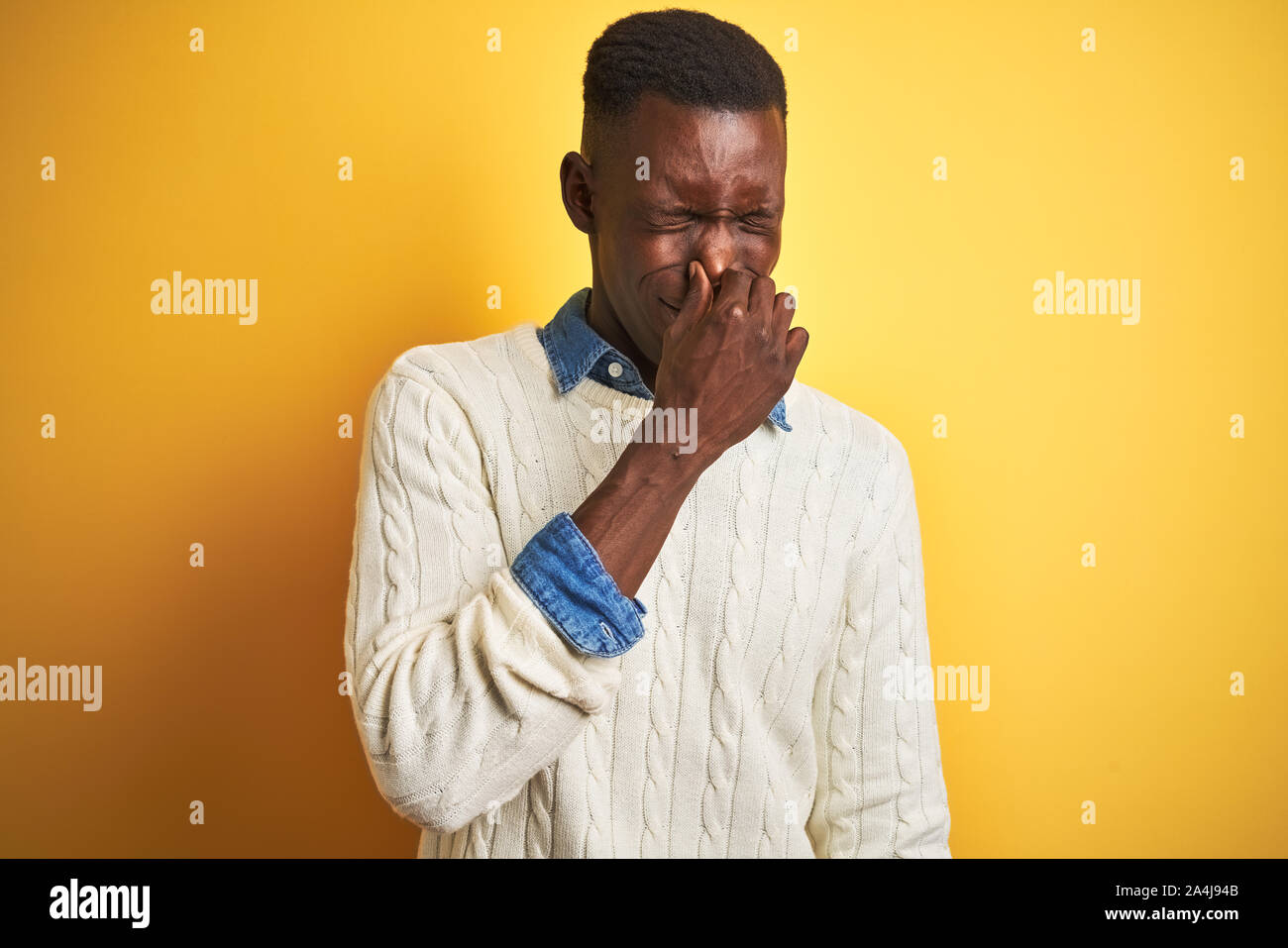 African american man wearing denim shirt and white sweater over ...