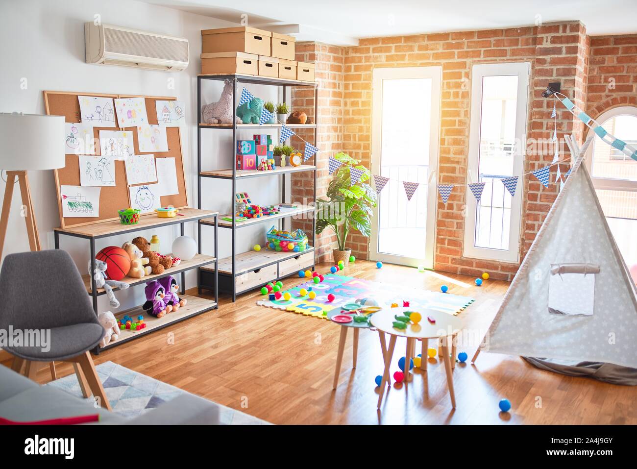 Picture of preschool playroom with colorful furniture, and toys around ...