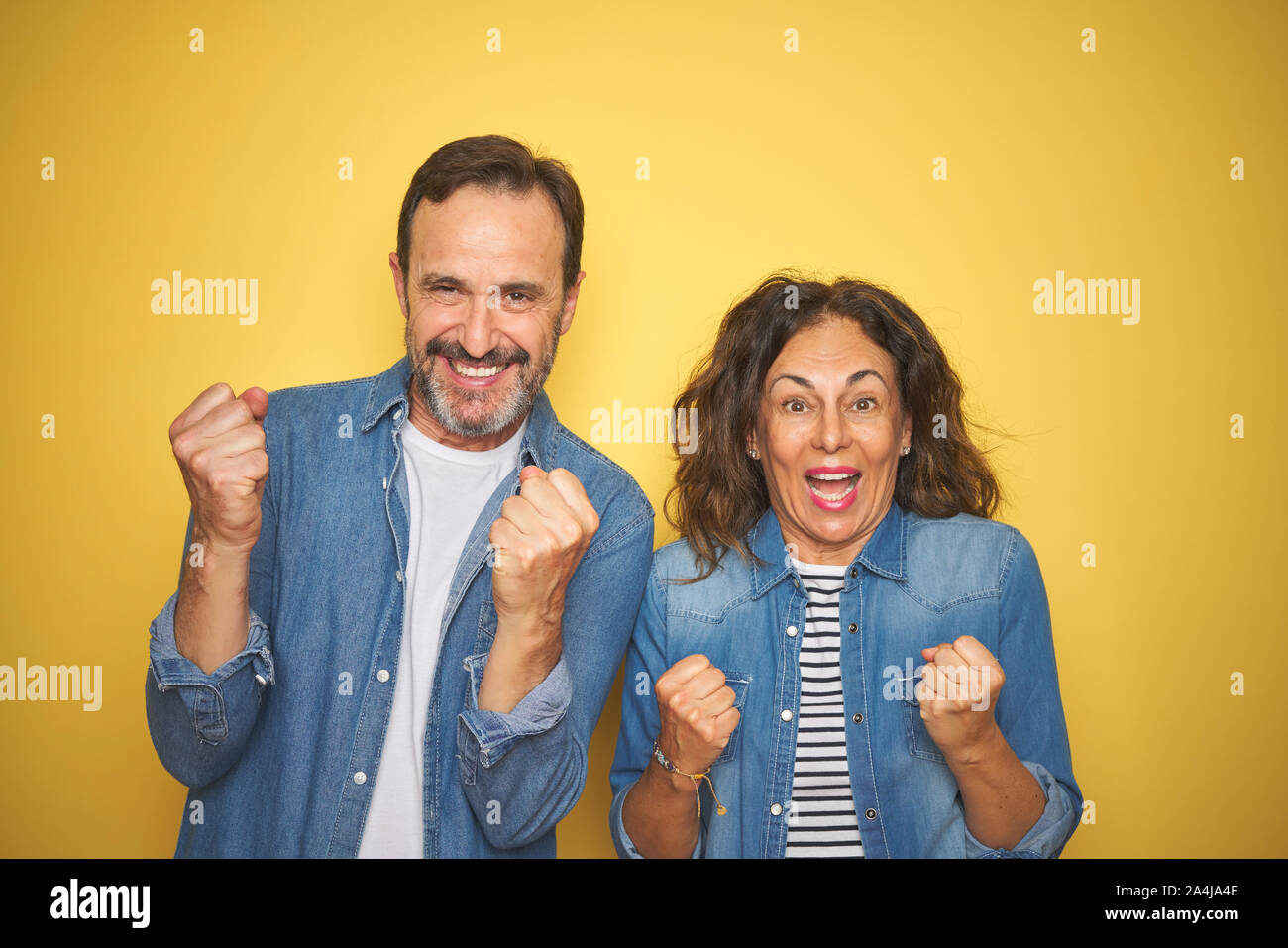 Beautiful middle age couple together wearing denim shirt over isolated ...