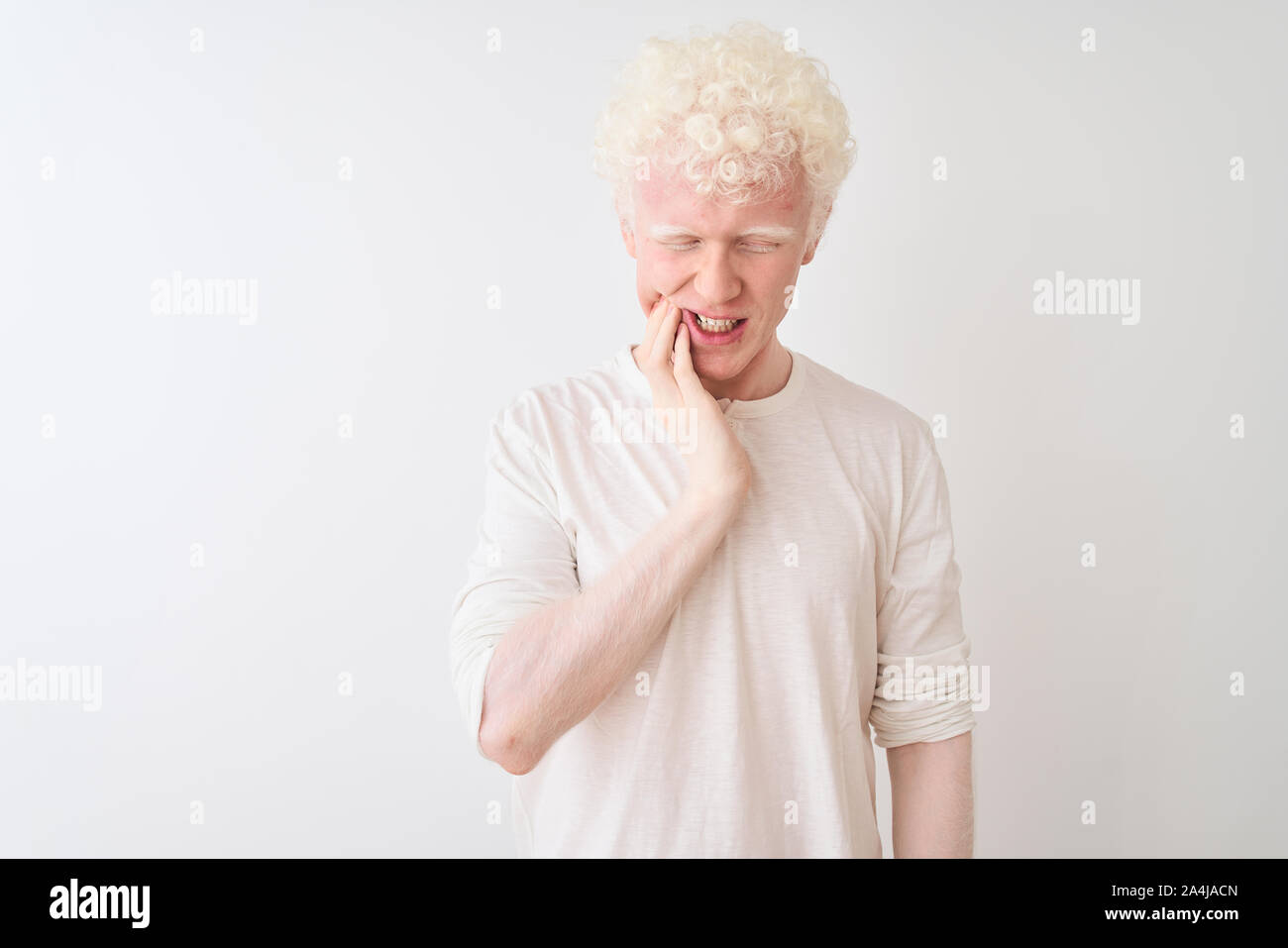 Young albino blond man wearing casual t-shirt standing over isolated ...