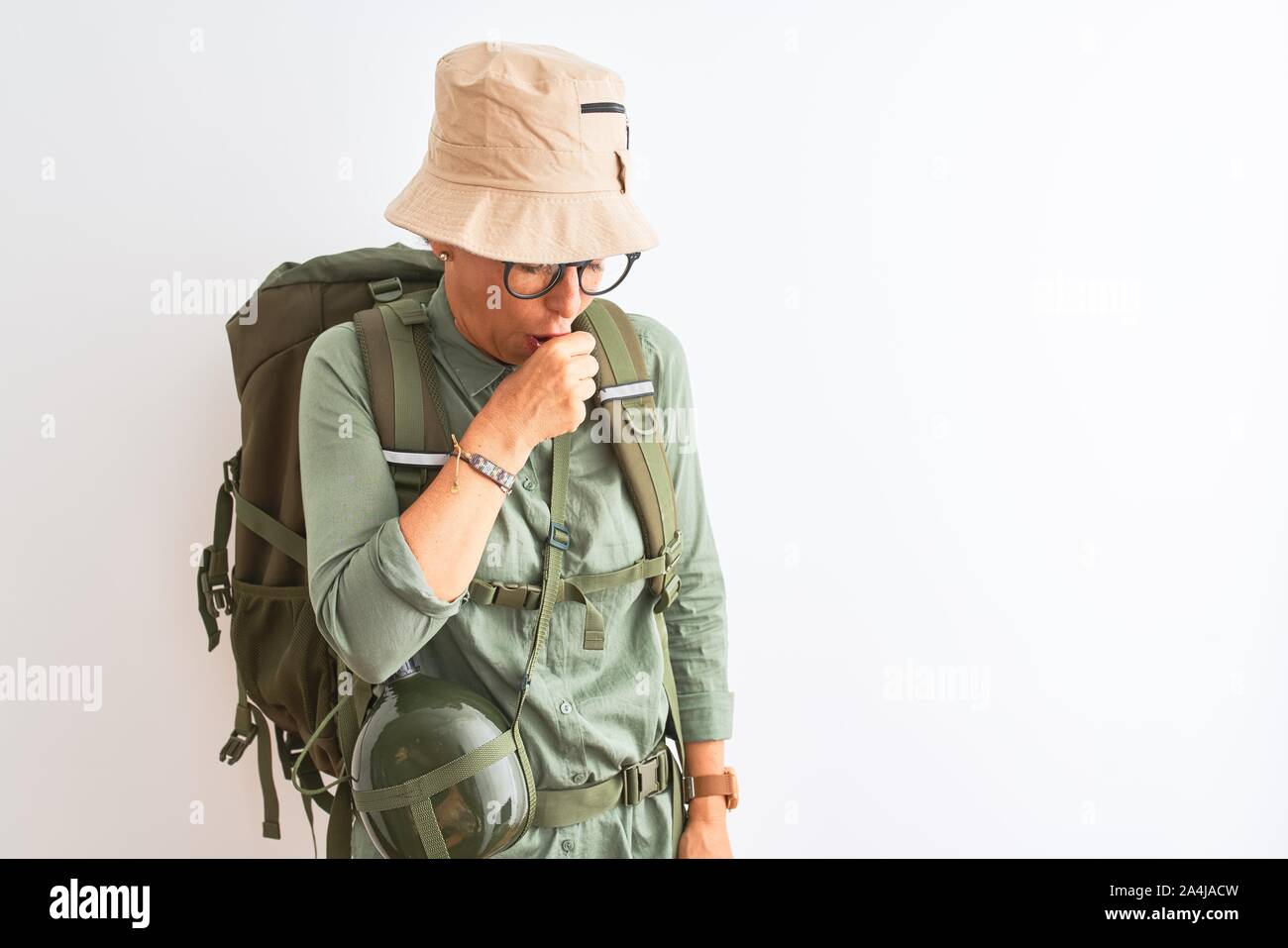 Middle age hiker woman wearing backpack canteen hat glasses over ...