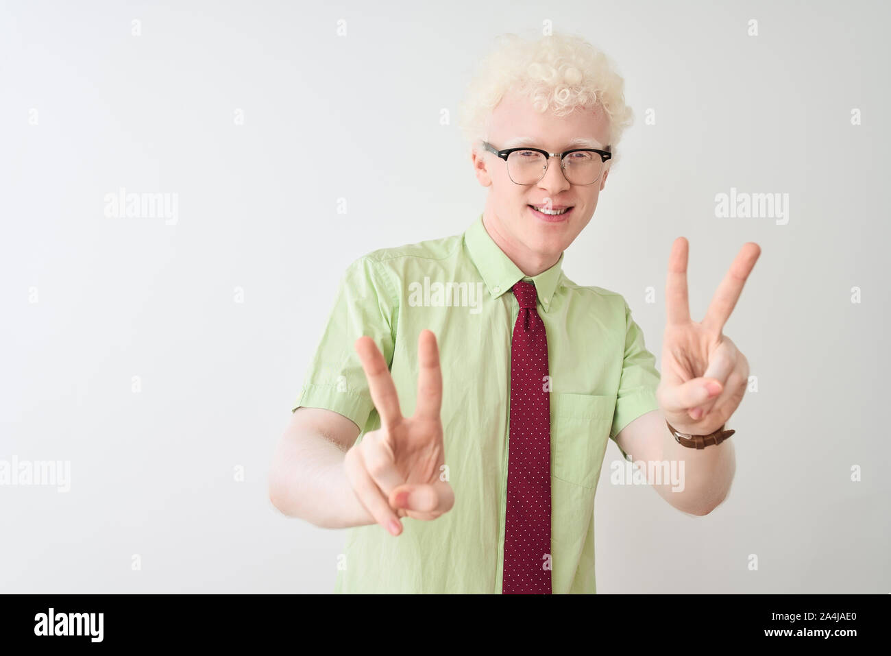 Young albino businessman wearing shirt and tie standing over isolated ...