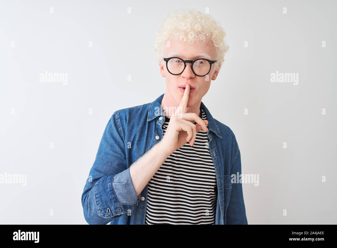 Young albino blond man wearing denim shirt and glasses over isolated ...