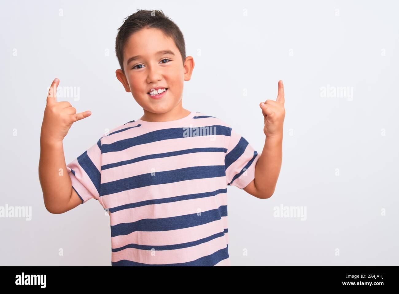 Beautiful kid boy wearing casual striped t-shirt standing over isolated ...